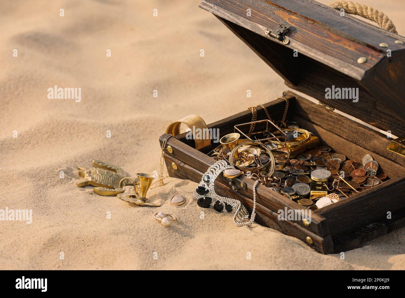 Open wooden treasure chest on sand, space for text Stock Photo - Alamy