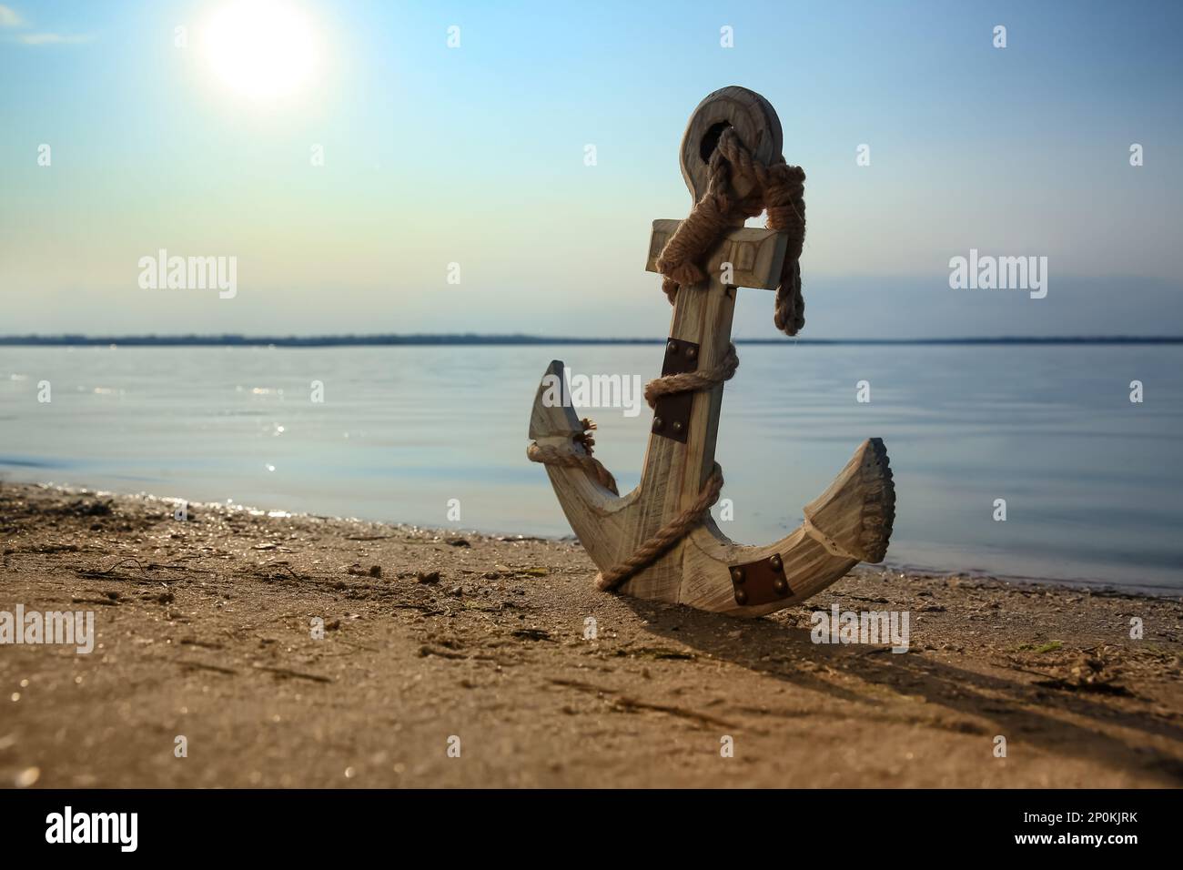 Wooden anchor on river shore near water Stock Photo - Alamy