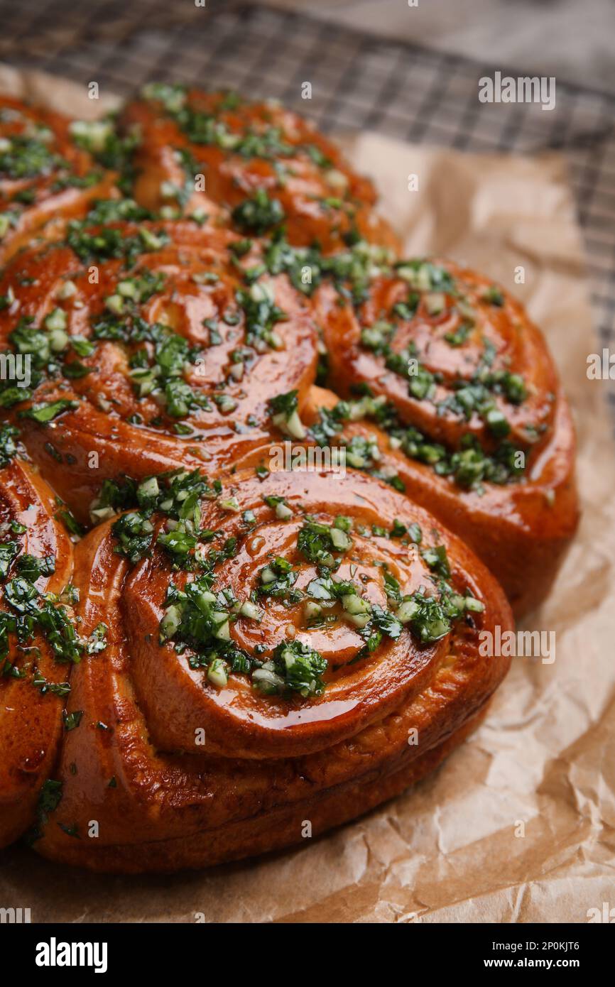 Traditional Ukrainian garlic bread with herbs (Pampushky) on parchment ...