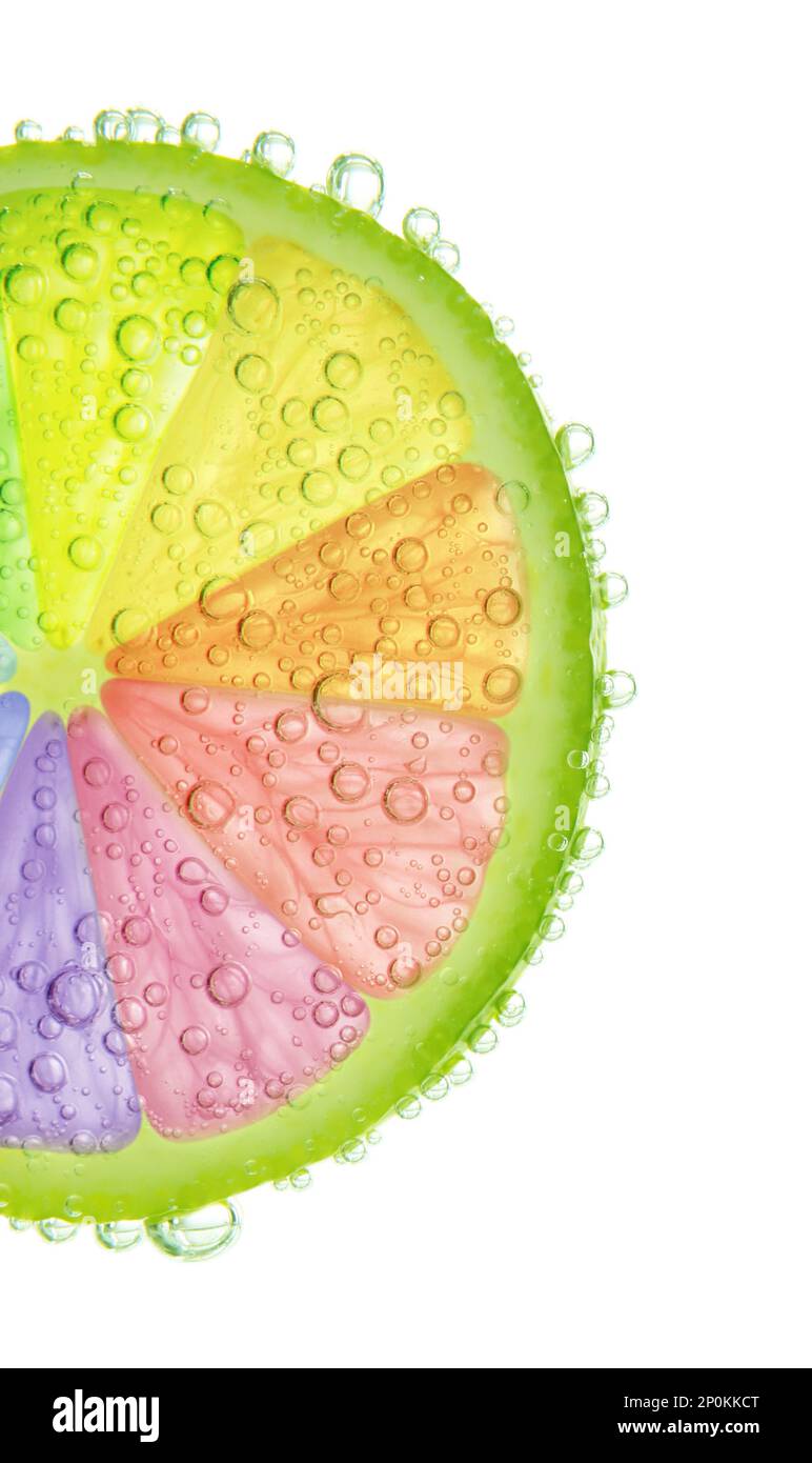 Fresh lime slice with rainbow segments and water bubbles on white ...