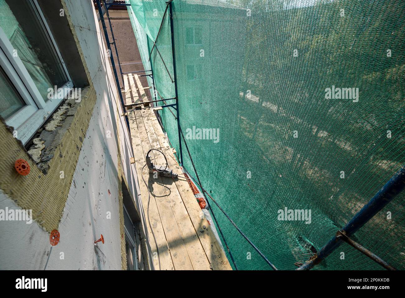 Hand drill on the scaffolding on altitude. Concept repairing the wall ...