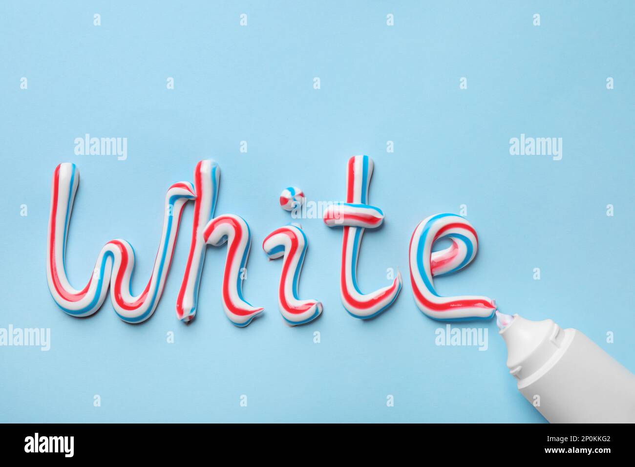 Tube and word White made of toothpaste on light blue background, flat ...