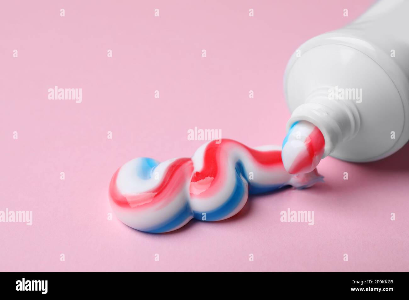 Tube with squeezed out toothpaste on pink background, closeup Stock ...