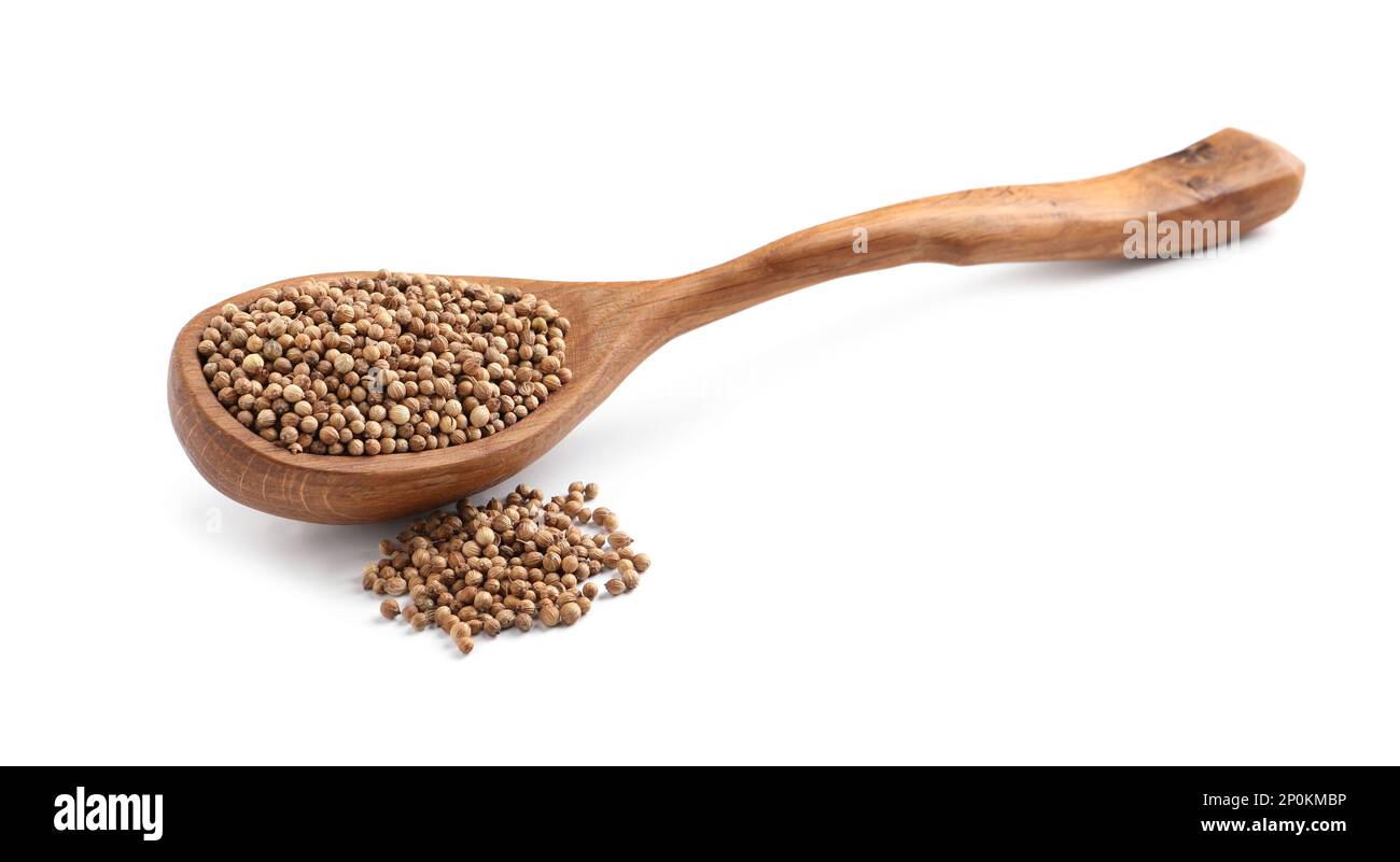 Dried coriander seeds with wooden spoon on white background Stock Photo - Alamy