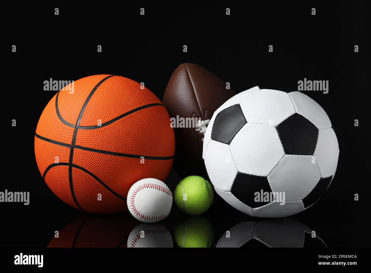 Set of different sport balls on black mirror surface Stock Photo - Alamy