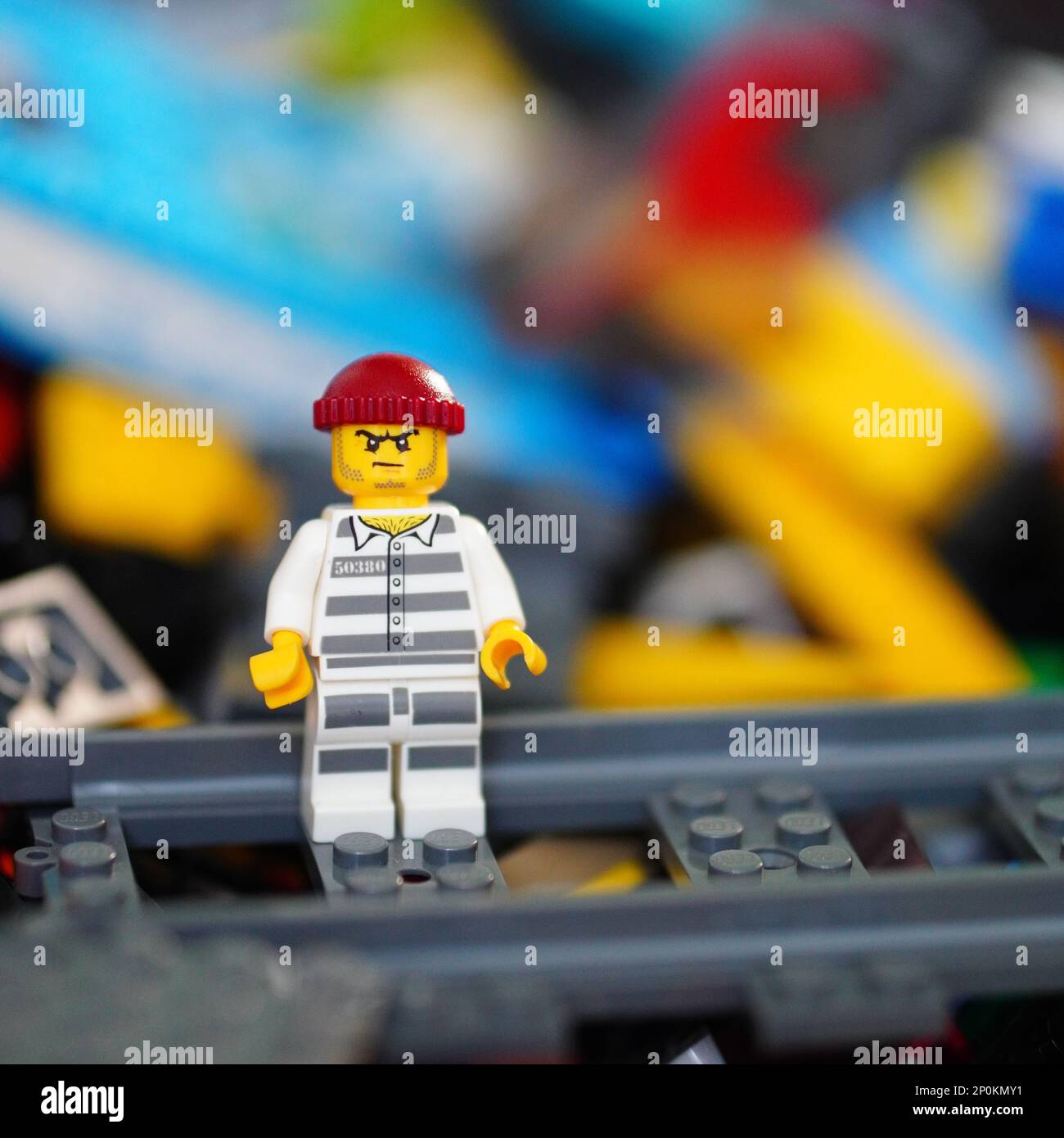 a close up of an angry prisoner lego figurene standing on a lego train ...