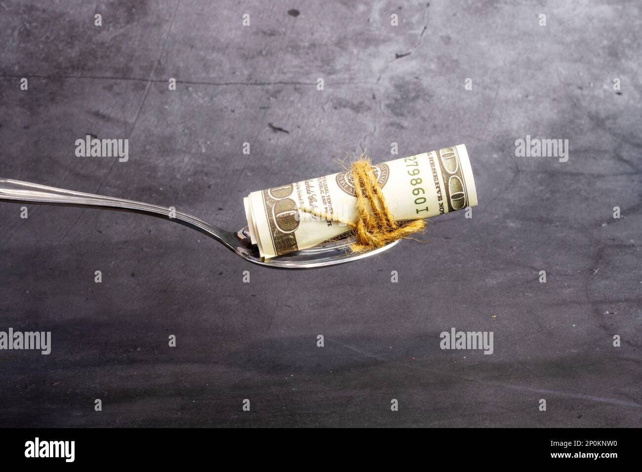Dollar paper bill, banknote, in the spoon on dark background. economy ...