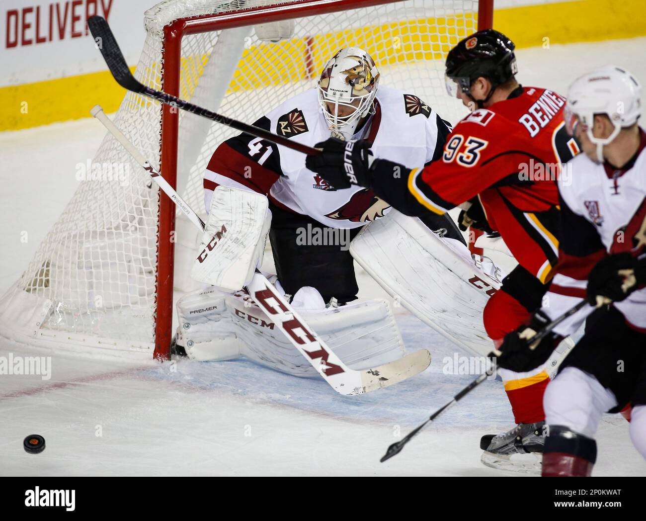 Arizona Coyotes goalie Mike Smith, left, looks on as Calgary Flames ...