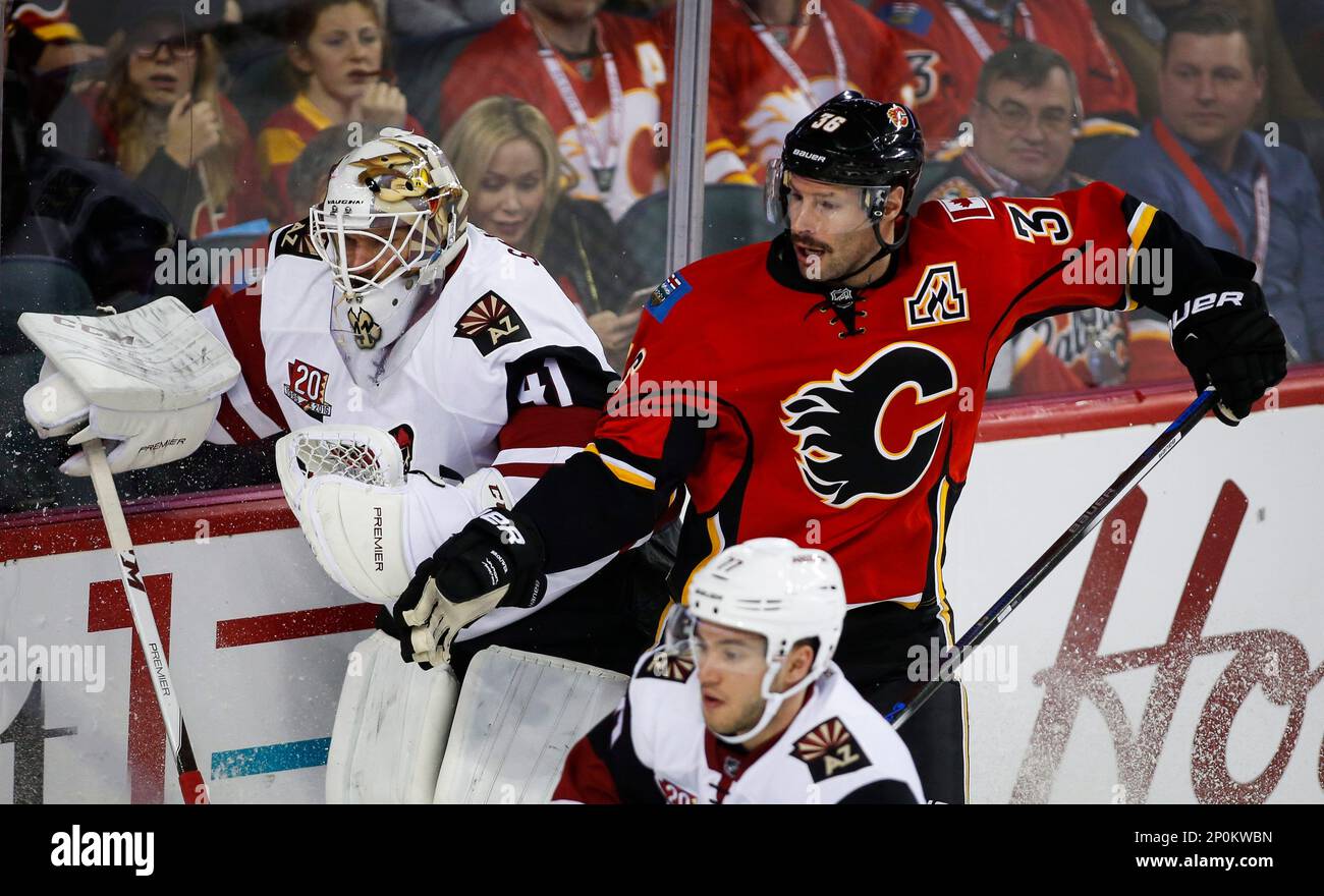 Arizona Coyotes goalie Mike Smith, left, blocks Calgary Flames' Troy ...