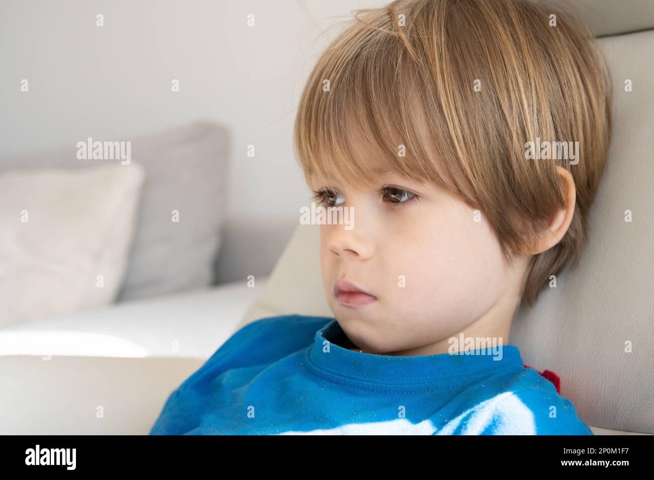 Cute angry boy. Morning home. Naughty little boy sitting on sofa Stock ...
