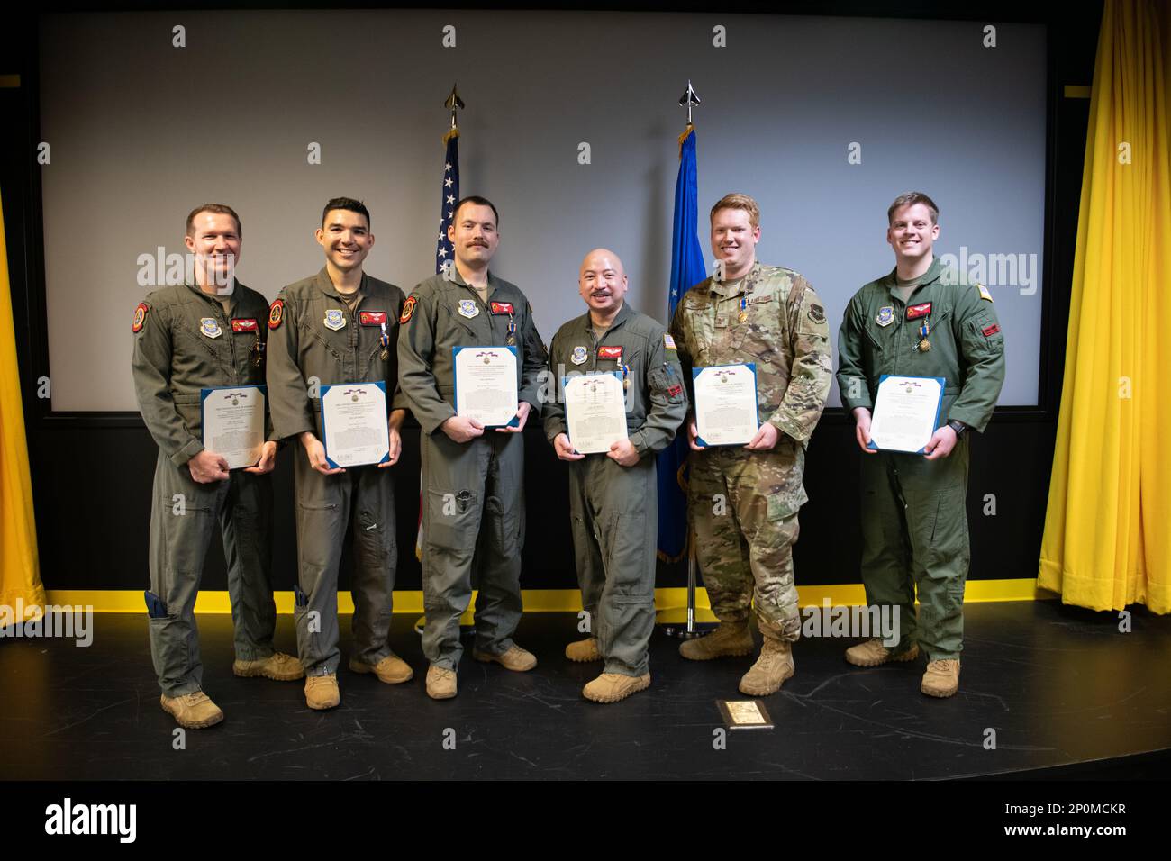 U.S. Airmen gather for a group photo holding their Air Medal citations ...