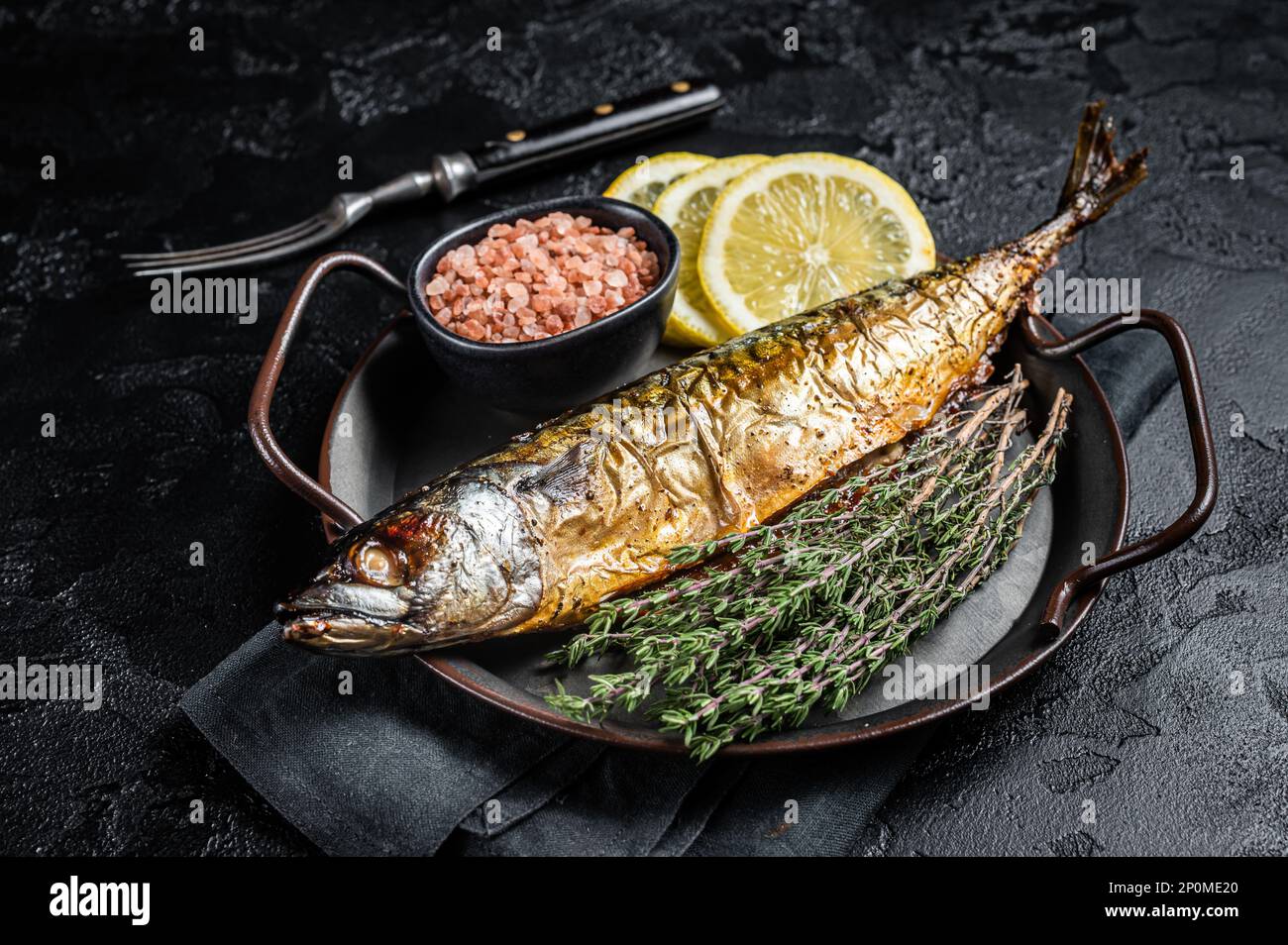Baked Mackerel Scomber fish in steel tray with thyme and lemon. Black ...