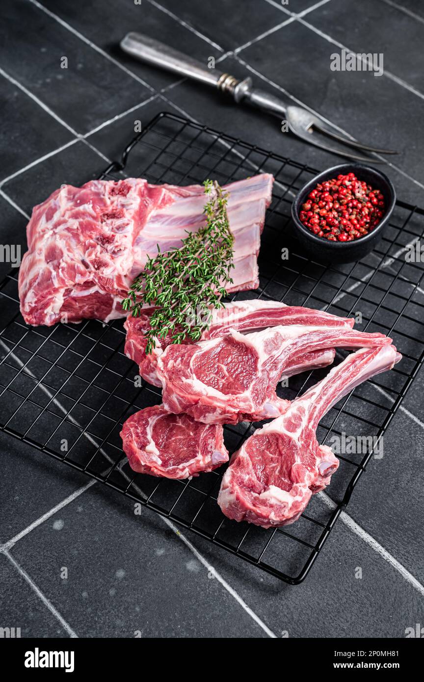 Fresh Raw lamb meat chop steaks on kitchen table with spices and herbs ...