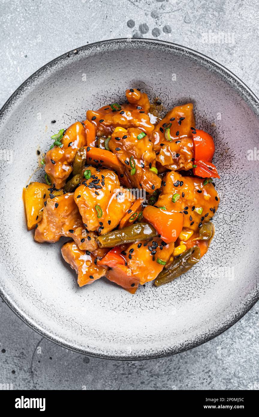 Chinese Sweet and Sour Pork guo bao rou in a bowl. Gray background. Top ...