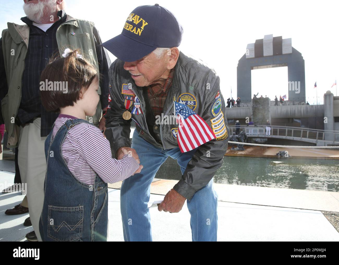 Emily Suhr, 3, of Roanoke, shakes hands veteran Ray Judd, 88, who ...