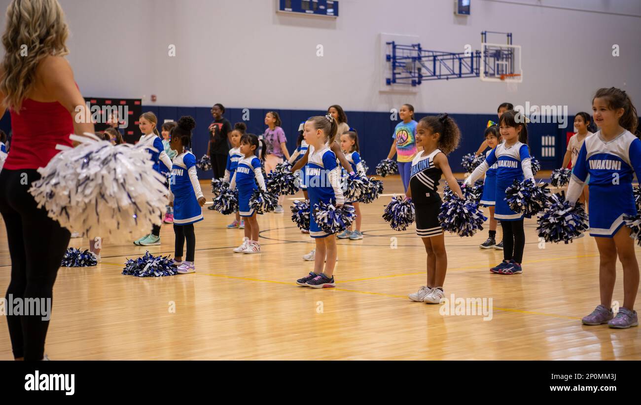 Marine Corps Air Station Iwakuni children perform a low-V pose with ...