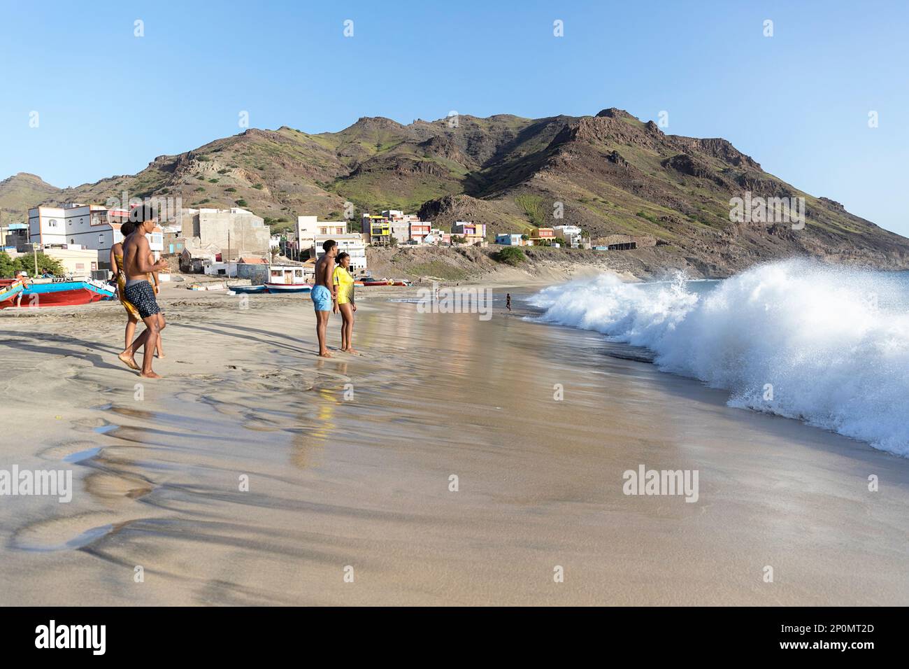 Local people enjoying on a Sao Pedro sandy beach with scenic mountains ...