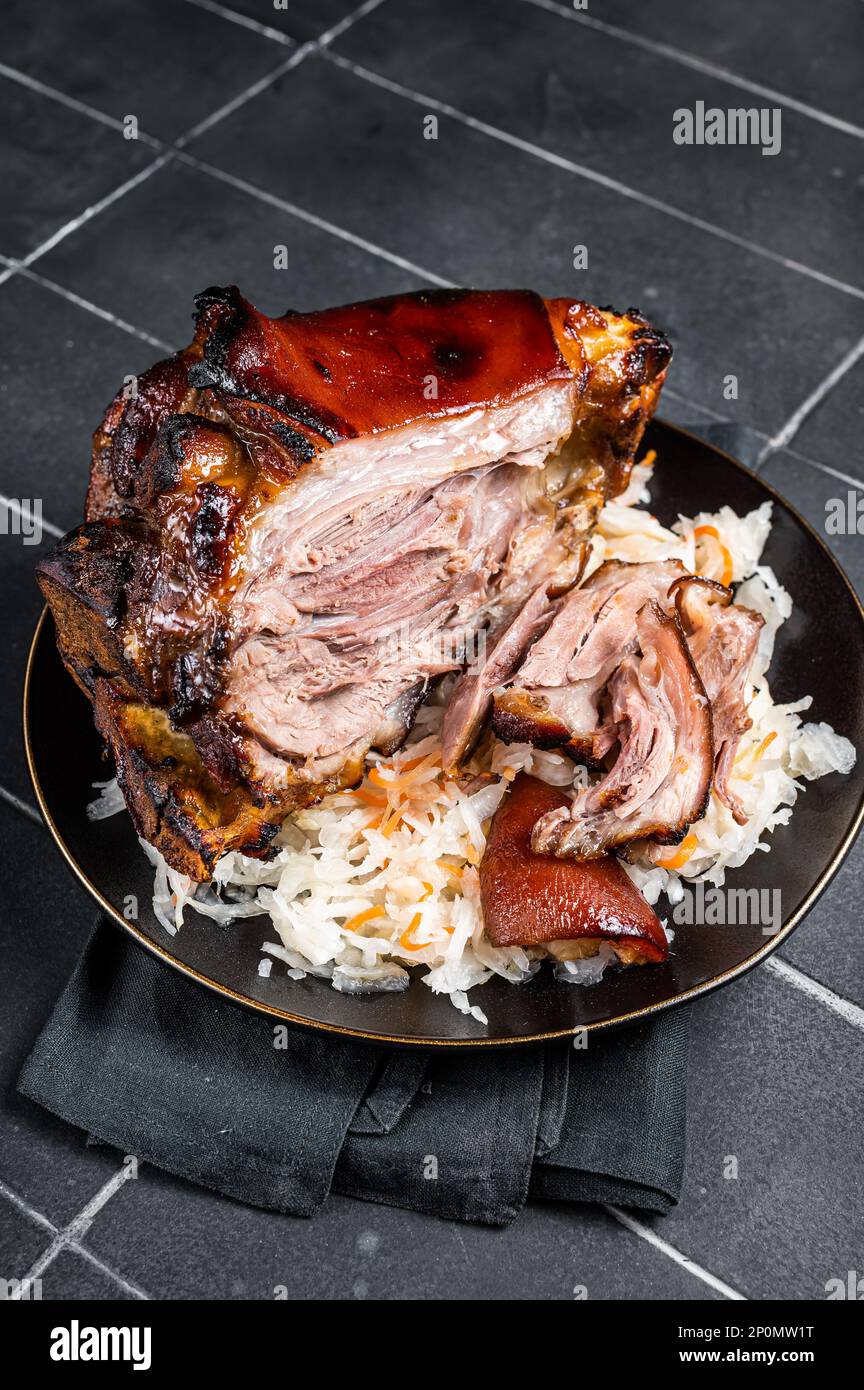 Roast Pork Ham Hock, knuckle with Sauerkraut on a plate. Black ...
