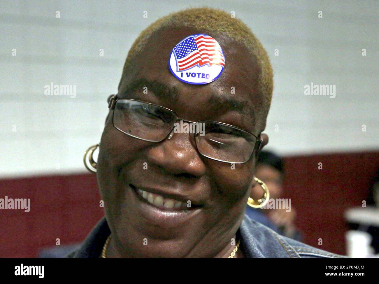 Michelle Crawford prominently displays her sticker as she casts her ...