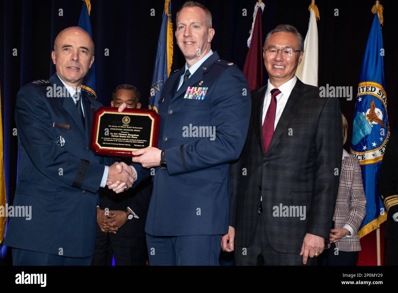 U.S. Air Force Lt. Col. Thomas Naughton is presented with the AMSUS ...