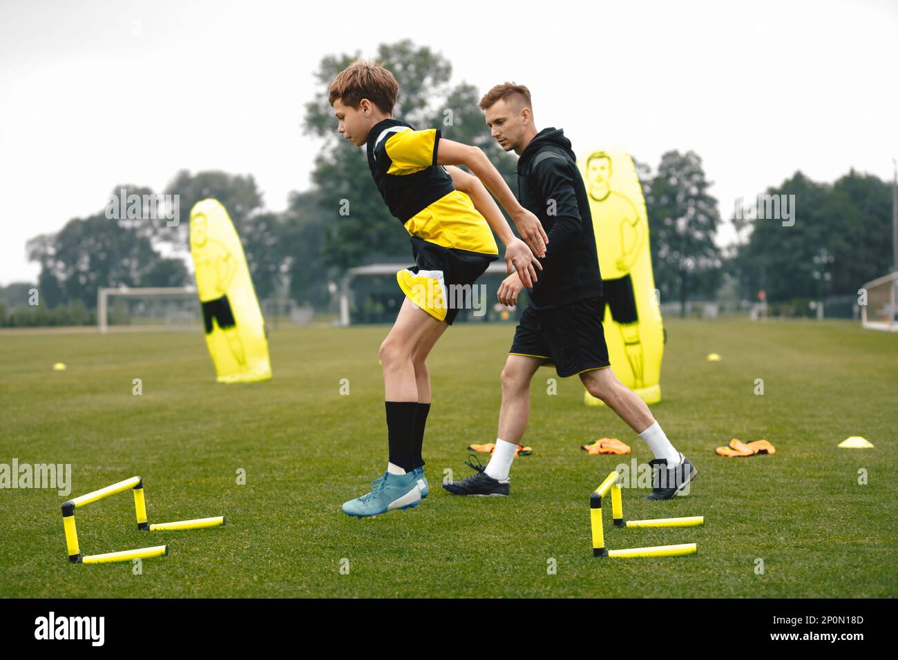 Teenage Boy at Training Drill With Young Soccer Coach. Youth Football ...