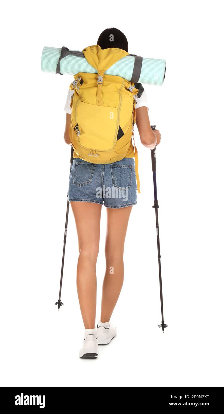 Female hiker with backpack and trekking poles on white background, back ...