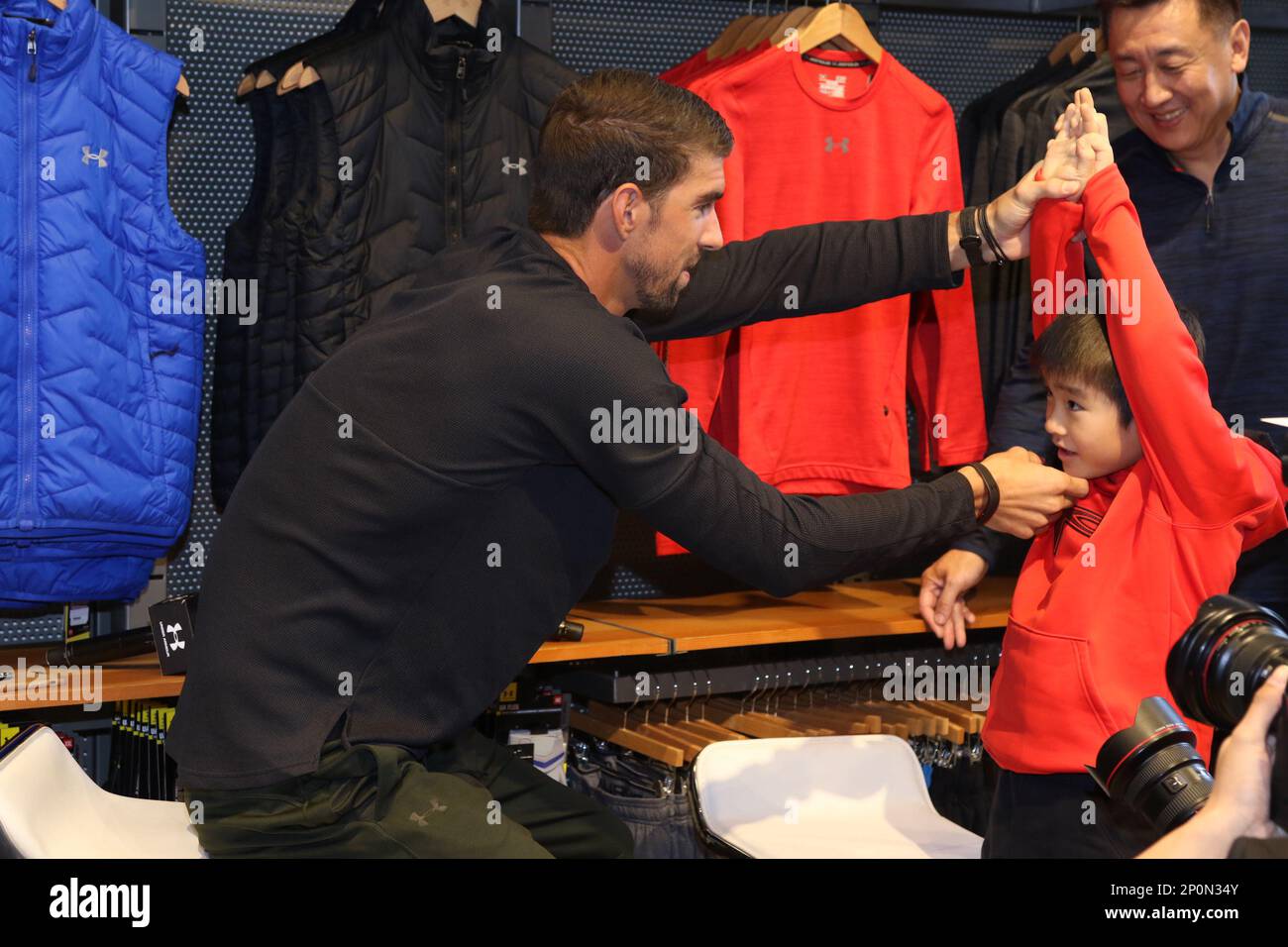American swimming star Michael Phelps, left, teaches a young boy to ...