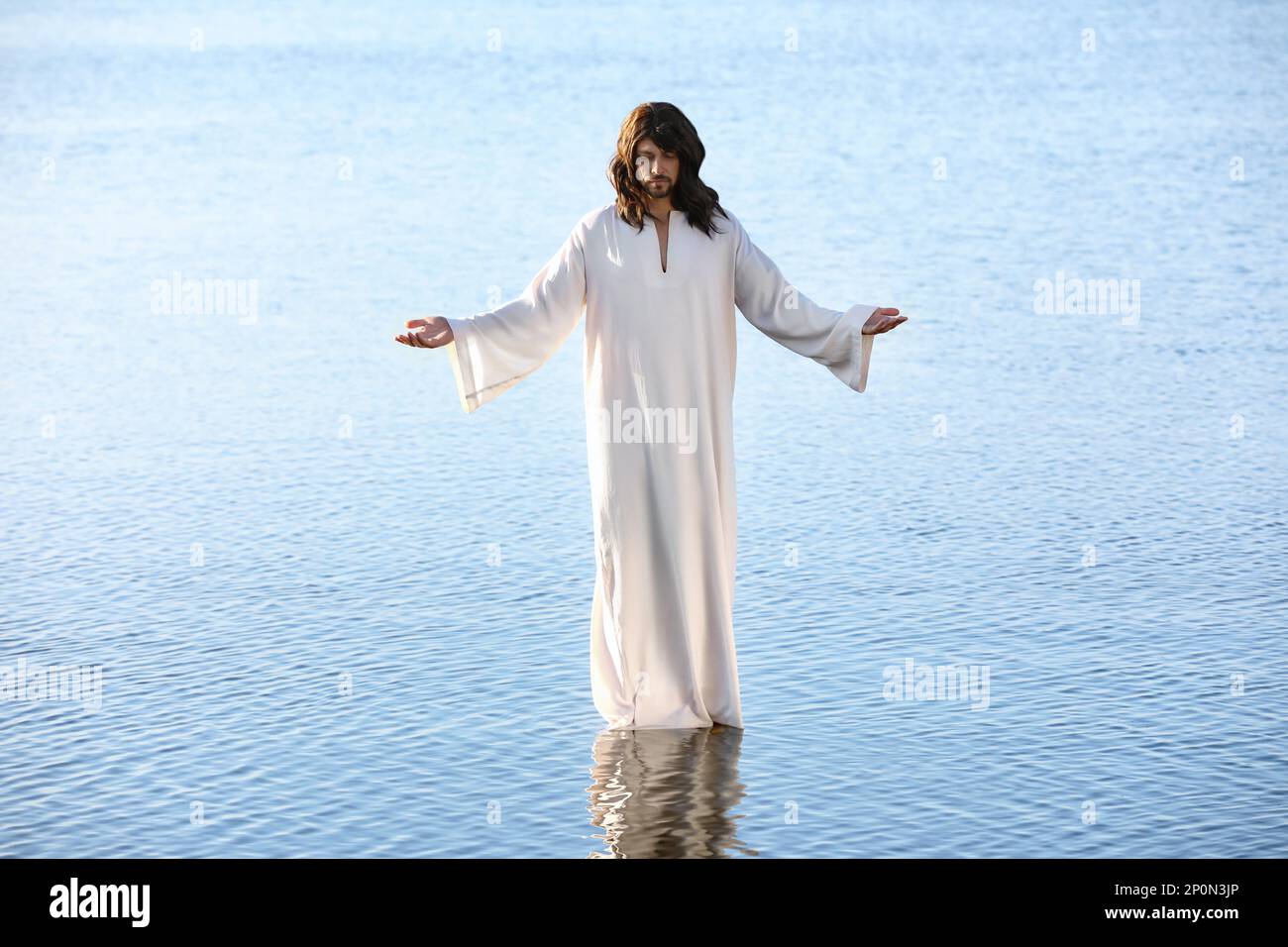 Jesus Christ in water lit by morning sun Stock Photo - Alamy