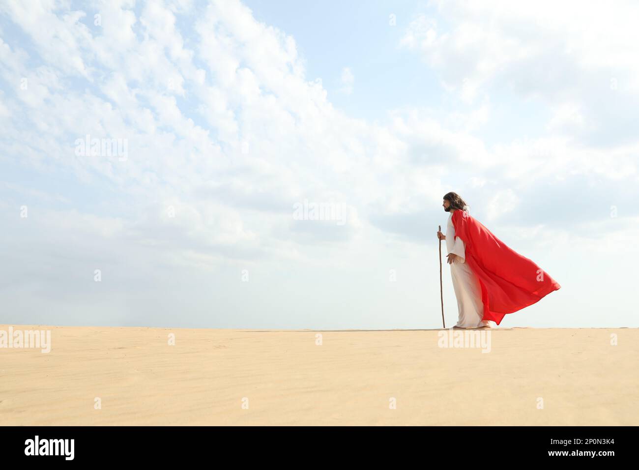 Jesus Christ walking with stick in desert. Space for text Stock Photo ...
