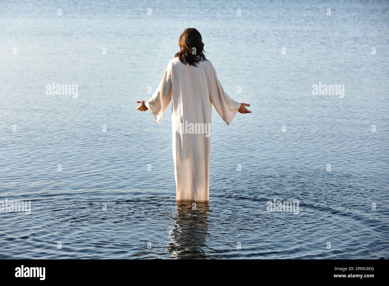 Jesus Christ in water lit by morning sun, back view Stock Photo - Alamy