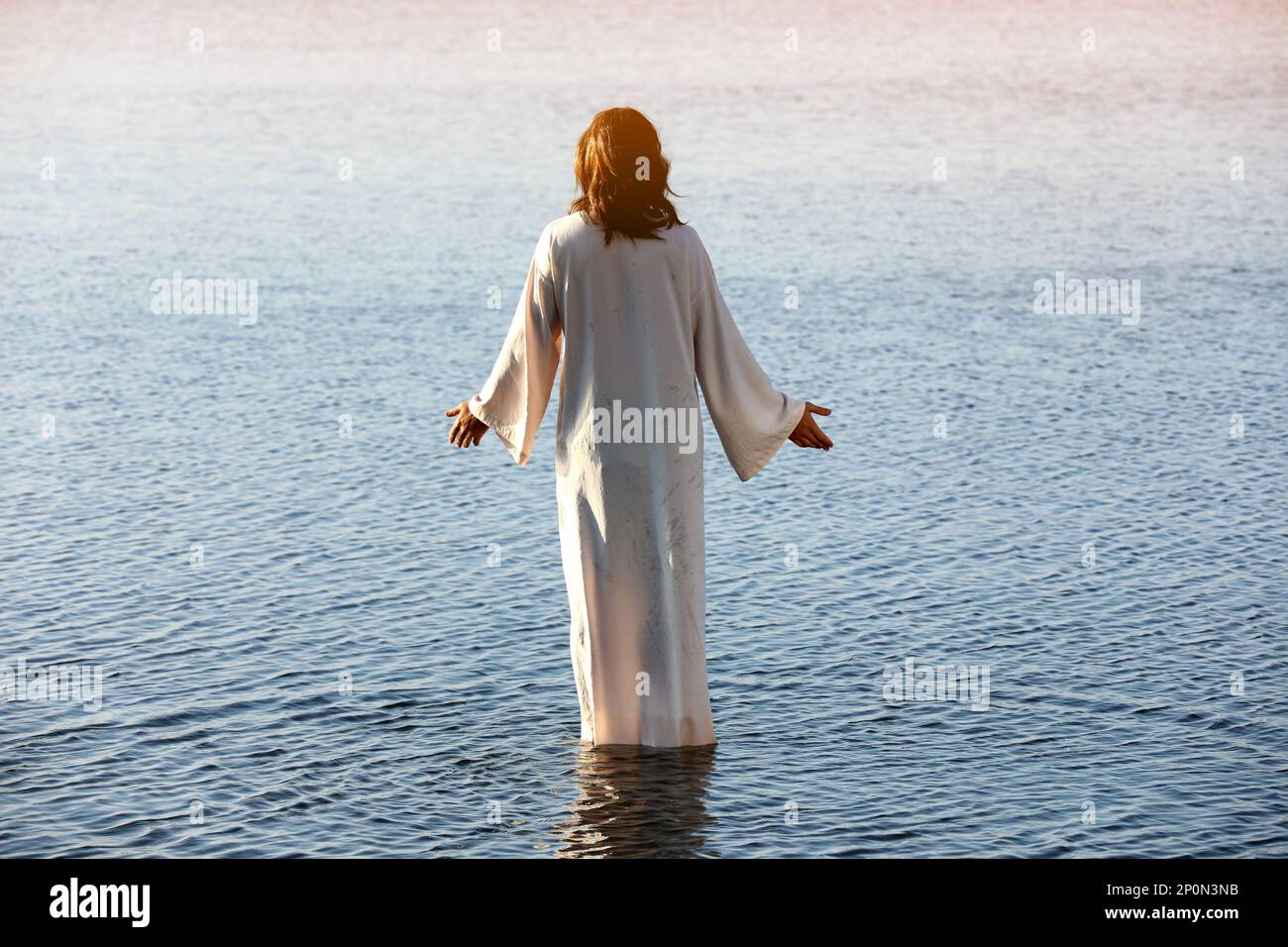 Jesus Christ in water lit by morning sun, back view Stock Photo - Alamy