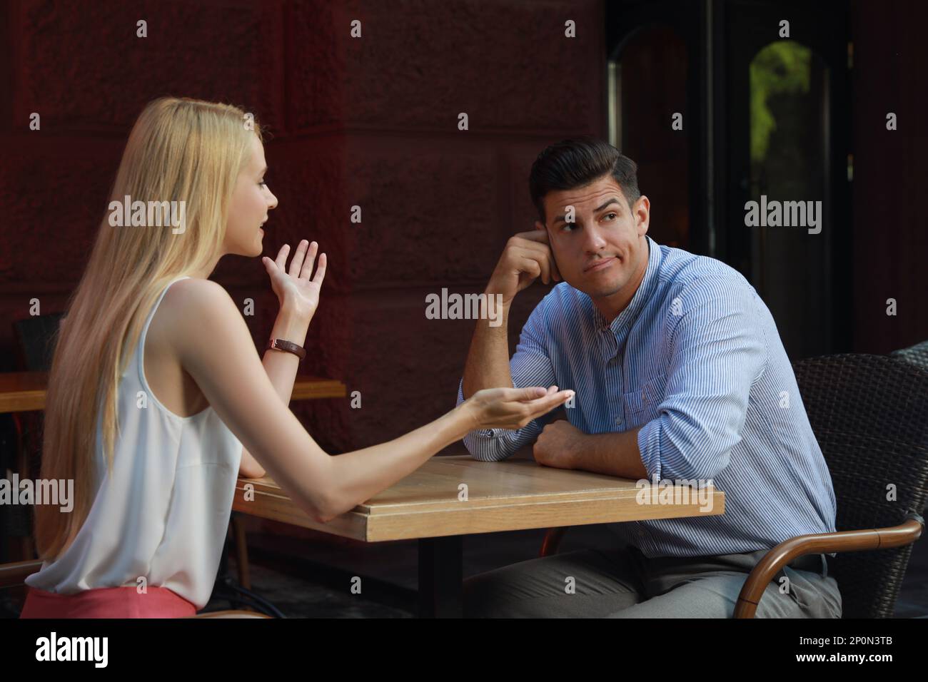 Man having boring date with talkative woman in cafe Stock Photo - Alamy