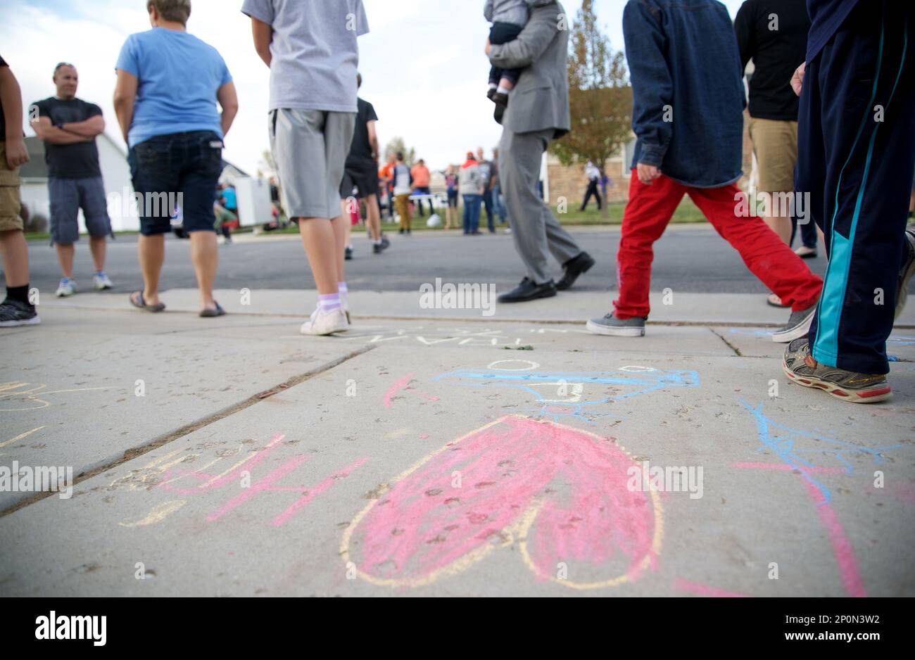 Chalk messages of love and support decorate the sidewalk outside the ...