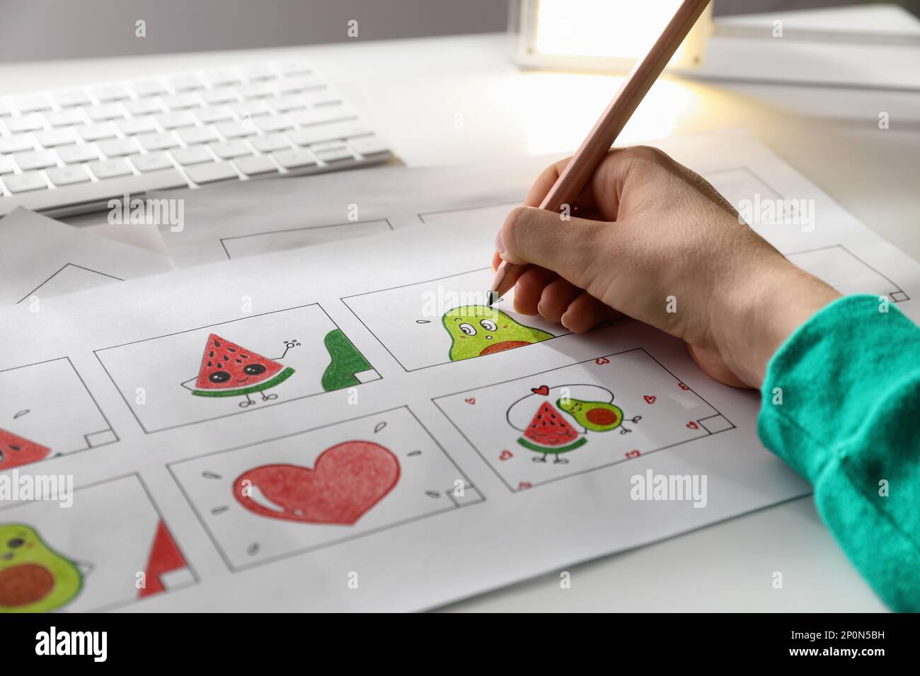 Woman drawing cartoon sketch at workplace, closeup. Pre-production ...