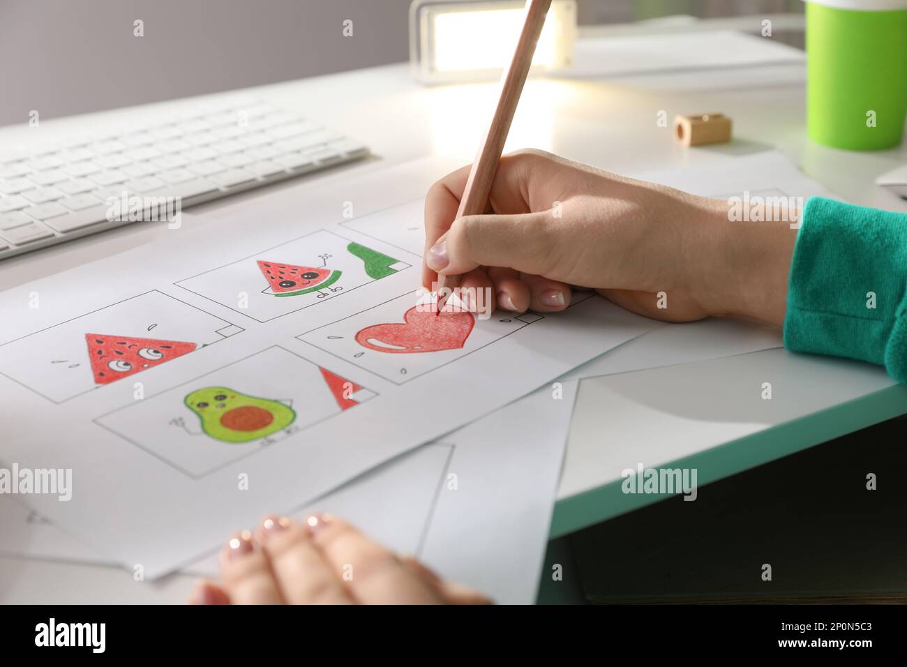 Woman drawing cartoon sketch at workplace, closeup. Pre-production ...