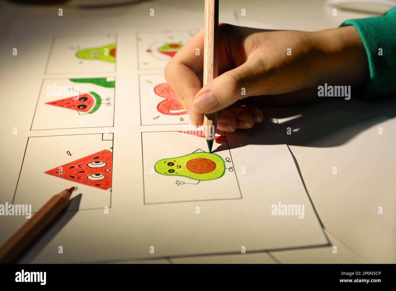 Woman drawing cartoon sketch at workplace, closeup. Pre-production ...