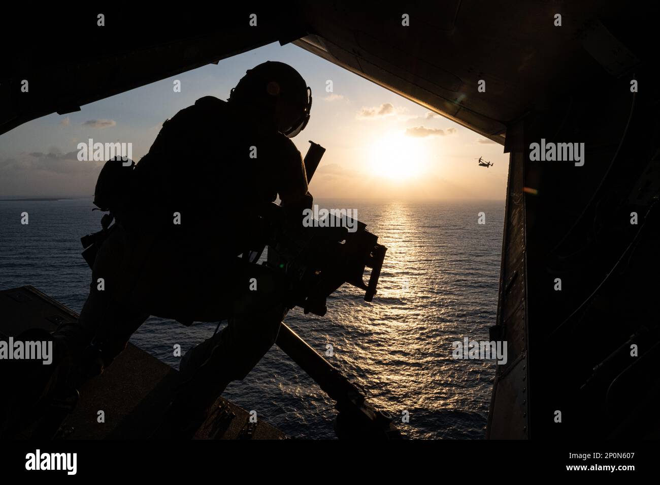 A U.S. Marine Corps MV-22 Osprey crew chief assigned to Marine Medium Tiltrotor Squadron 266 ...