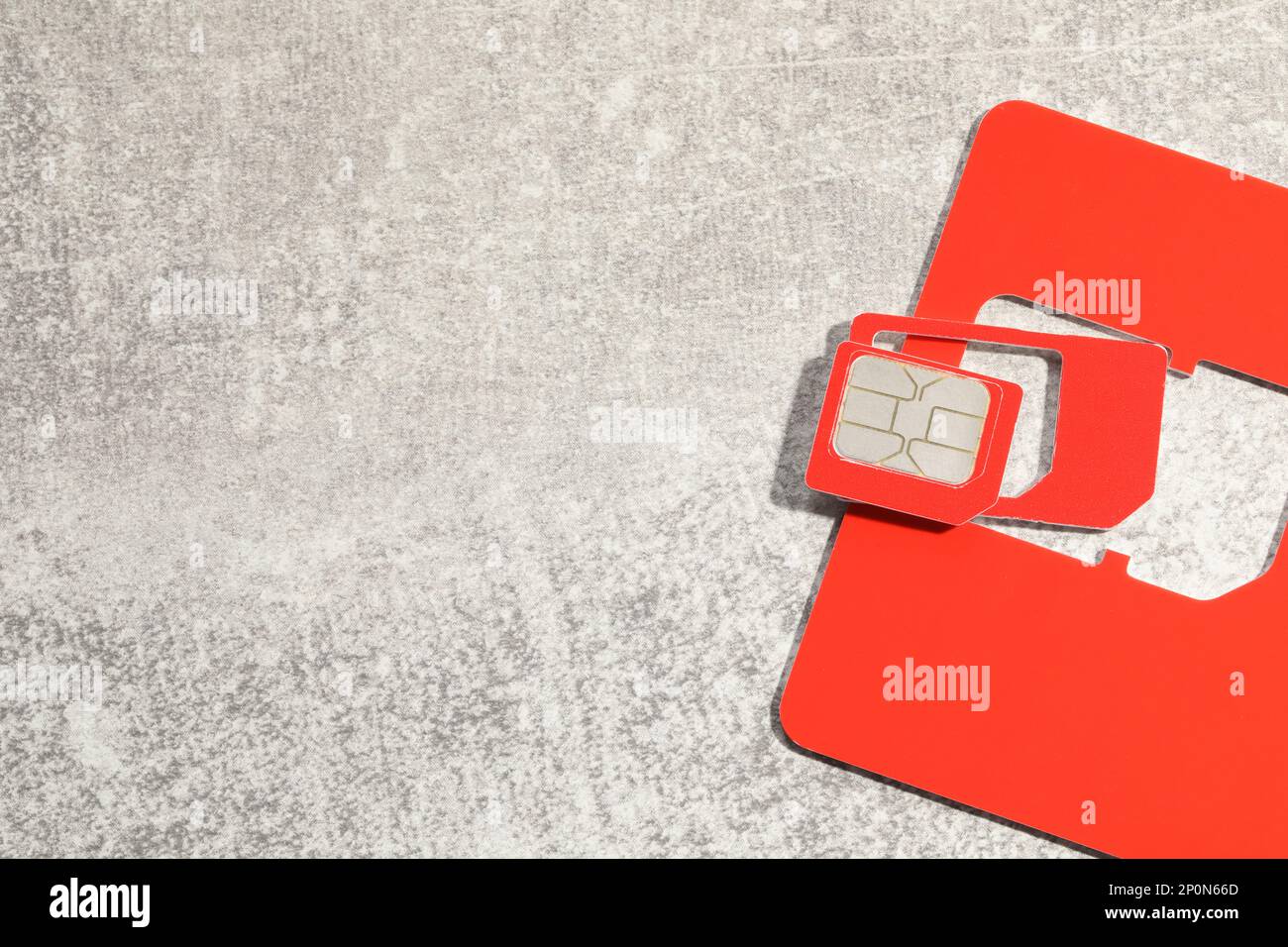 Multi SIM card on light grey stone background, top view. Space for text ...