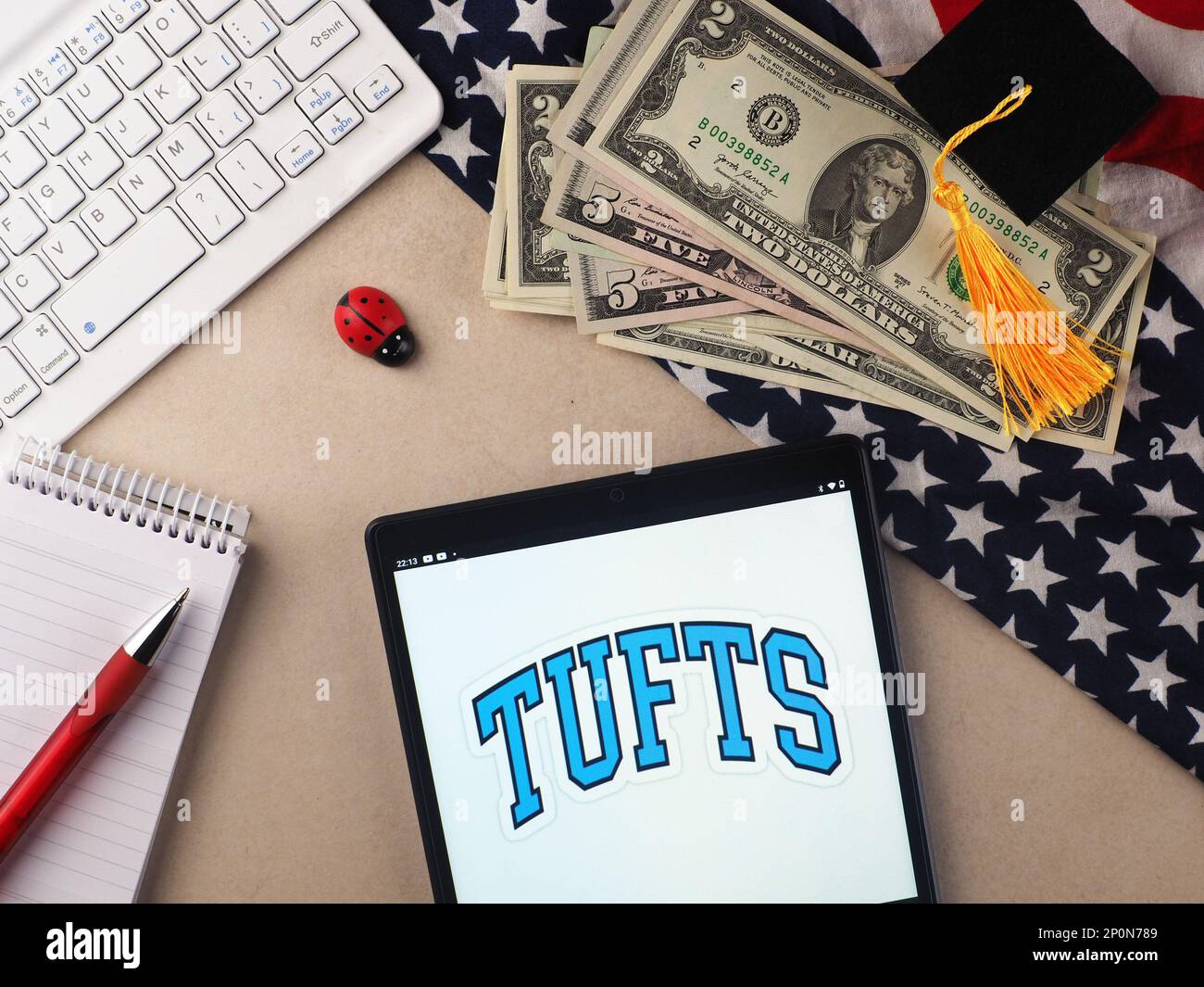In this photo illustration, Tufts University logo seen displayed on a ...