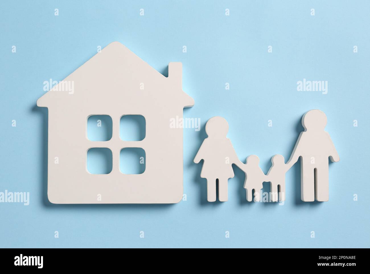 Family and house figures on light blue background, flat lay Stock Photo ...