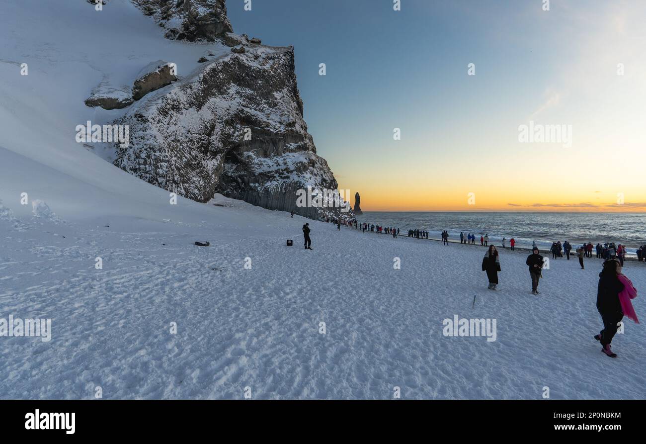 Reynisfjara beach completely covered in snow and the basalt formations ...