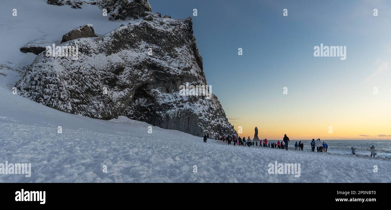Reynisfjara beach completely covered in snow and the basalt formations ...