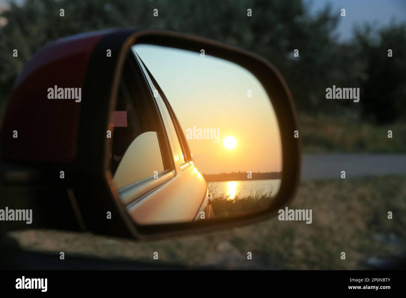 Reflection of landscape with beautiful sunset over calm river in car ...