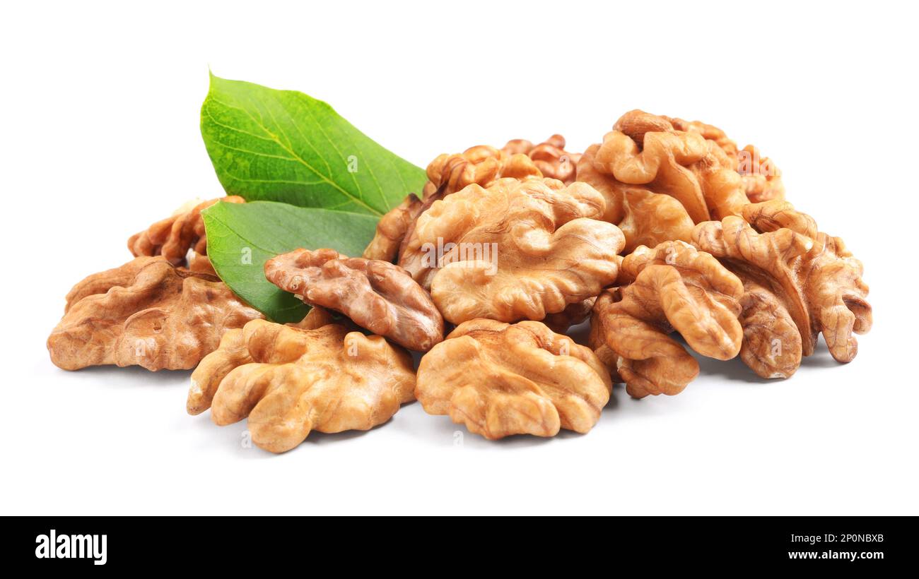Pile of peeled walnuts and leaves on white background Stock Photo - Alamy