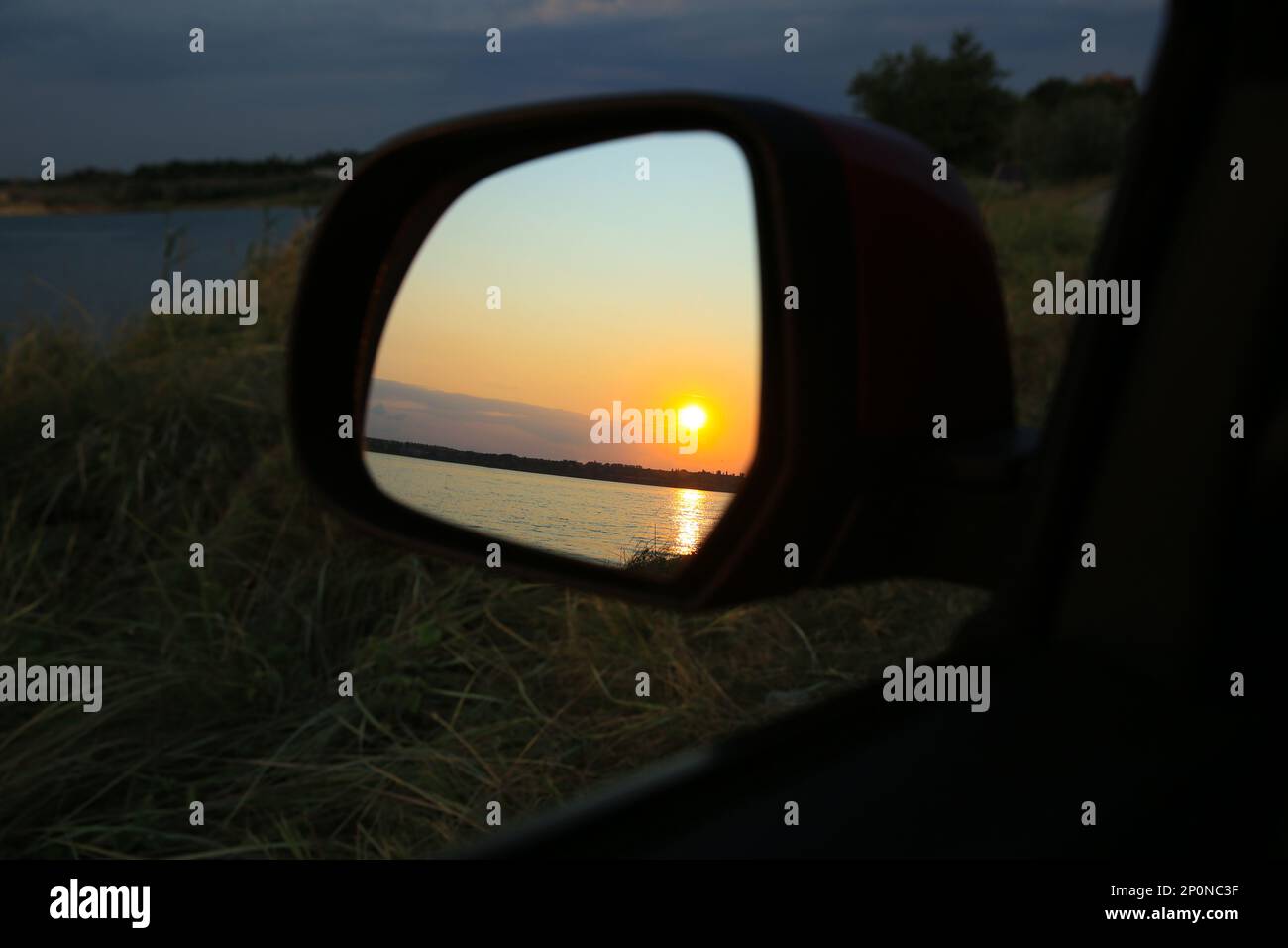 Reflection of landscape with beautiful sunset over calm river in car ...