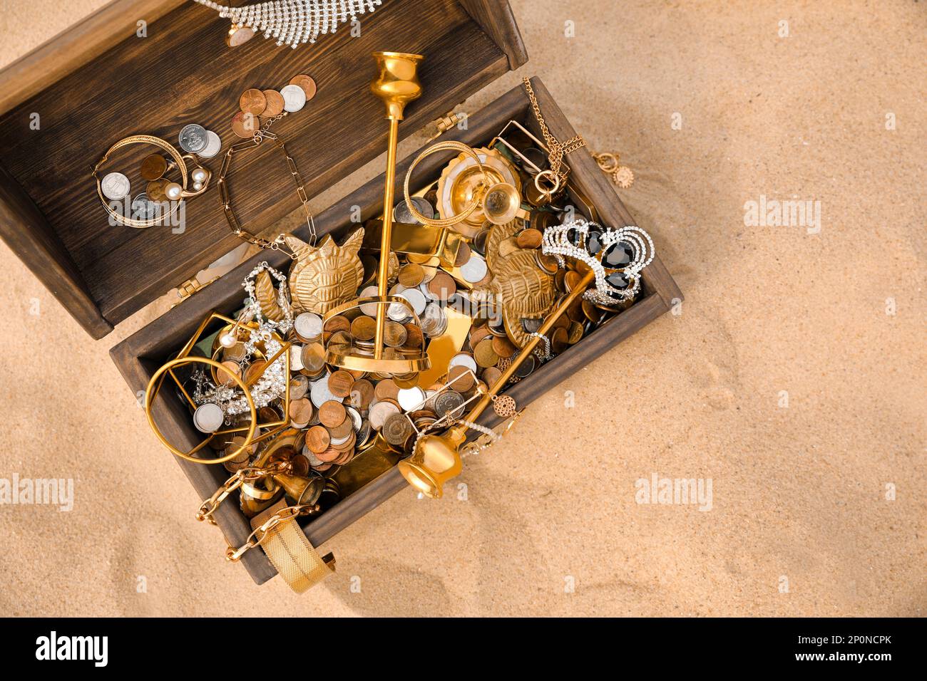 Open wooden treasure chest on sand, above view. Space for text Stock ...