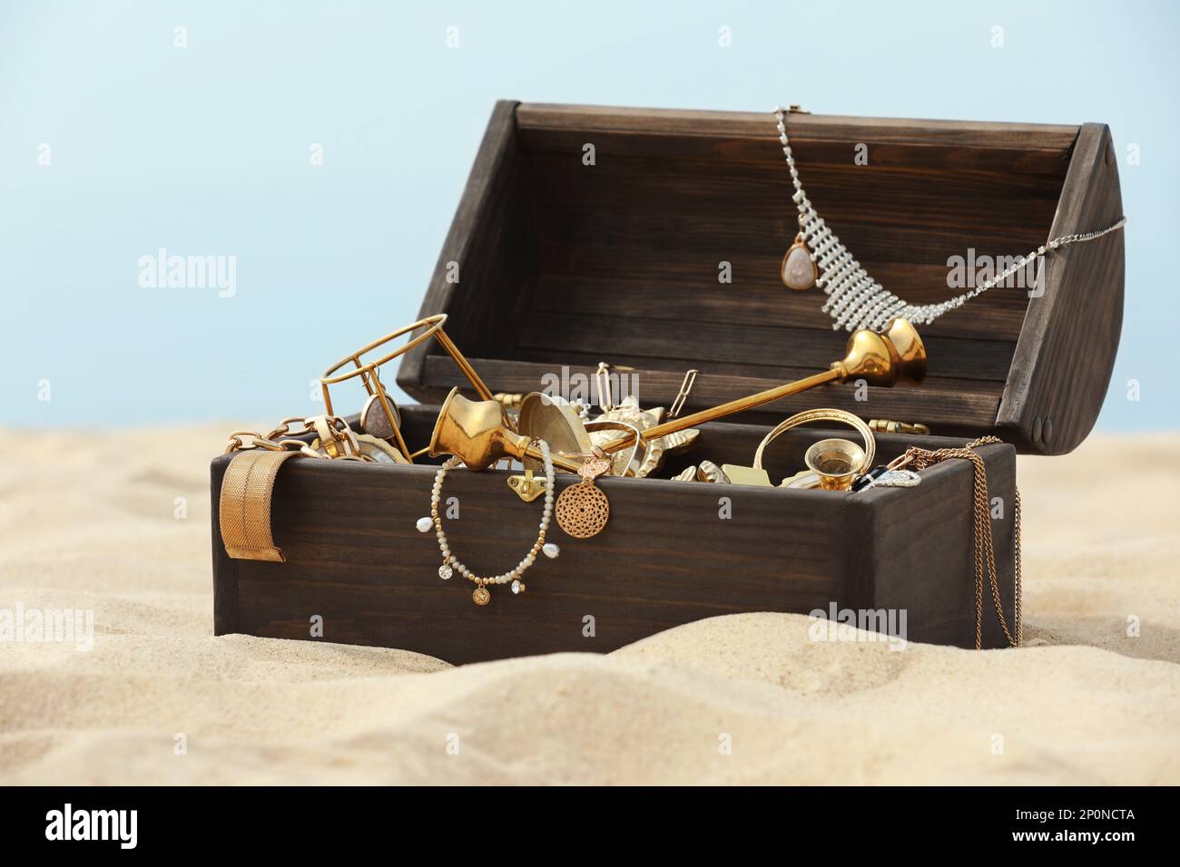 Open wooden treasure chest on sandy beach Stock Photo - Alamy