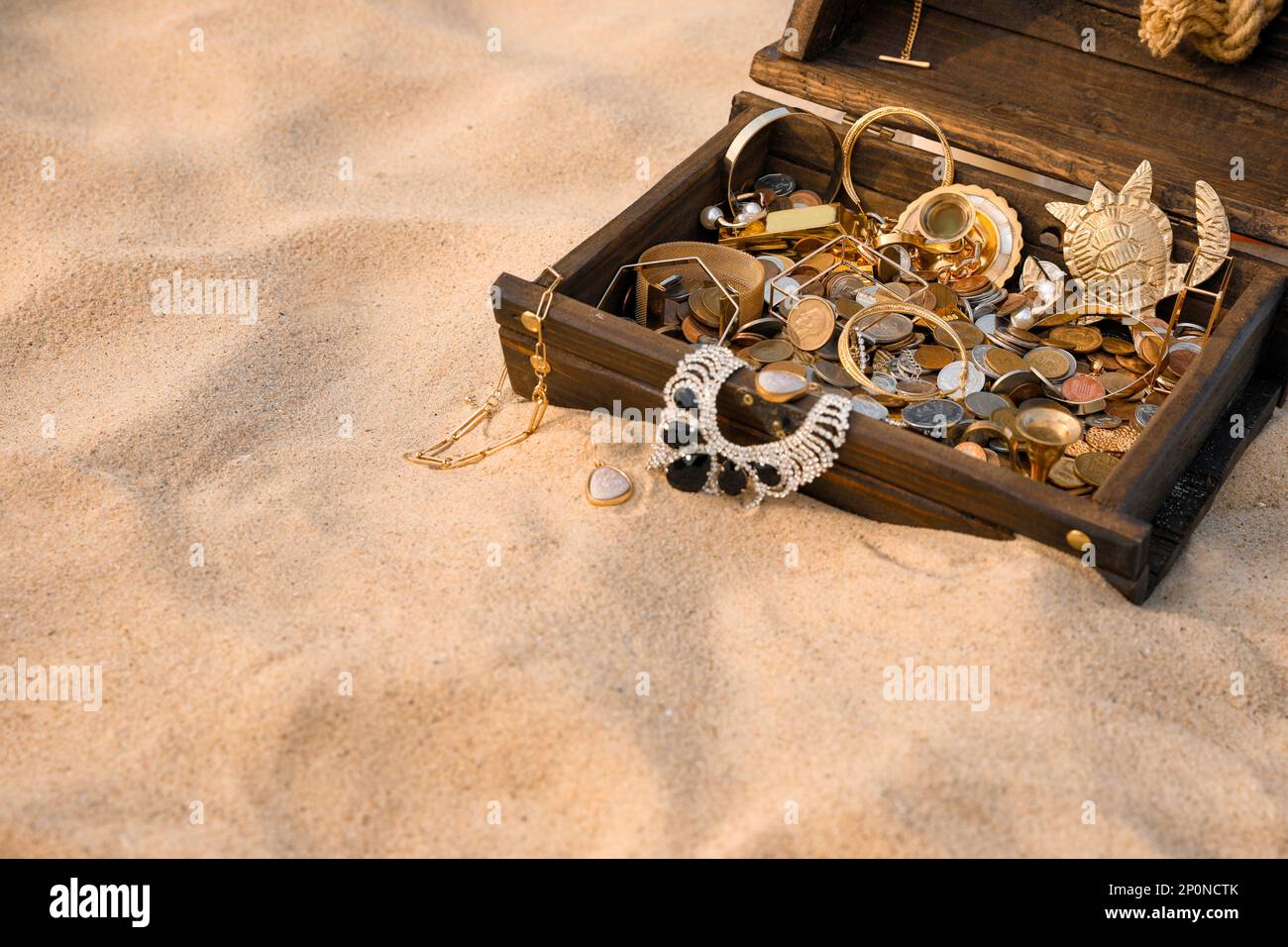 Open wooden treasure chest on sand, space for text Stock Photo - Alamy
