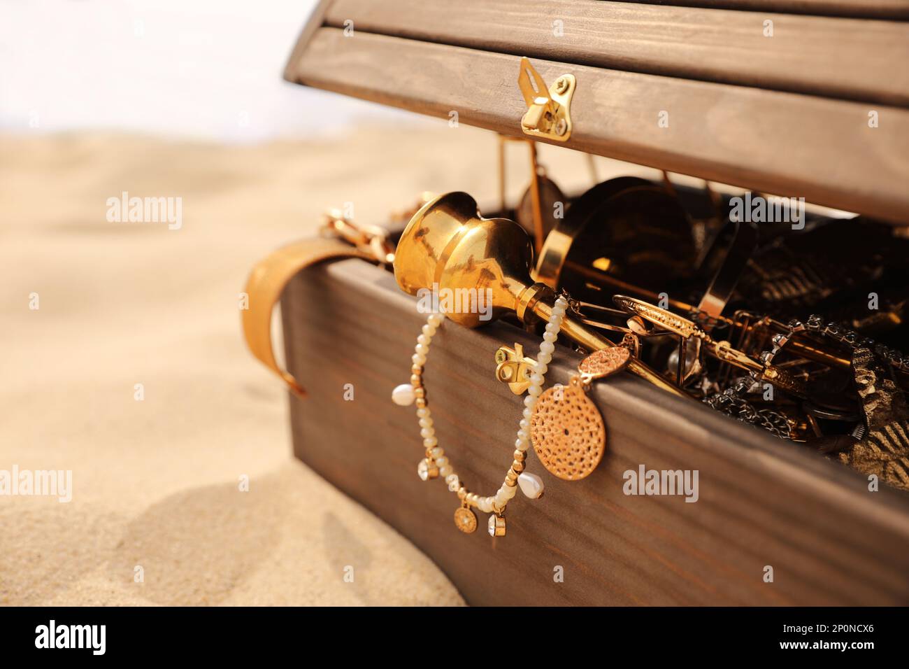 Open wooden treasure chest on sandy beach, closeup Stock Photo - Alamy