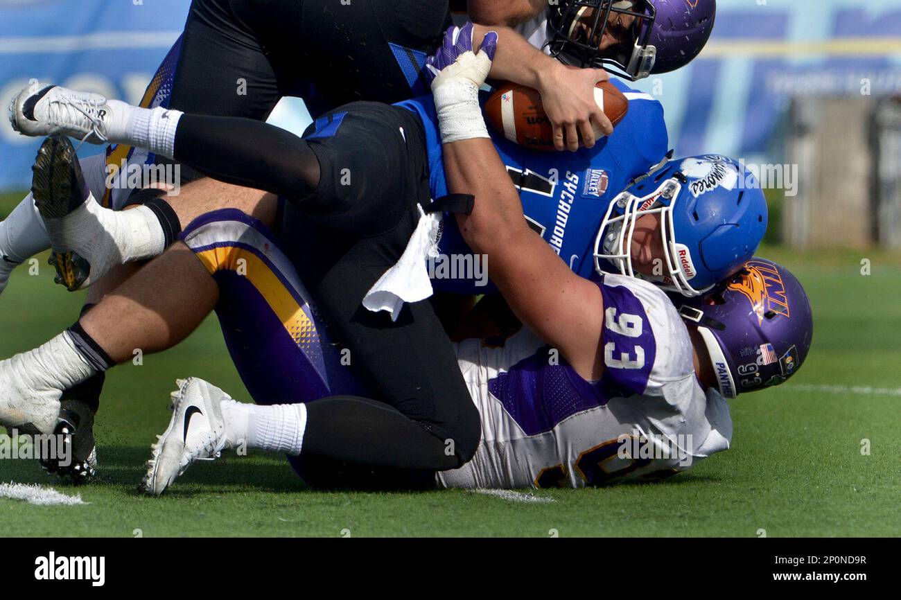 Indiana State quarterback Isaac Harker is pulled to the turf by ...